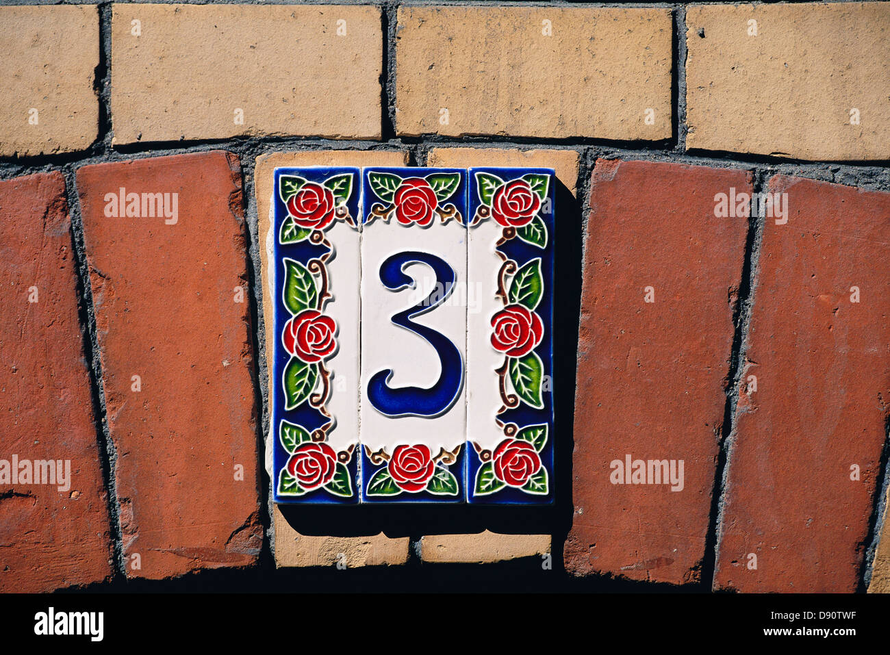Number on tile with designs Stock Photo - Alamy
