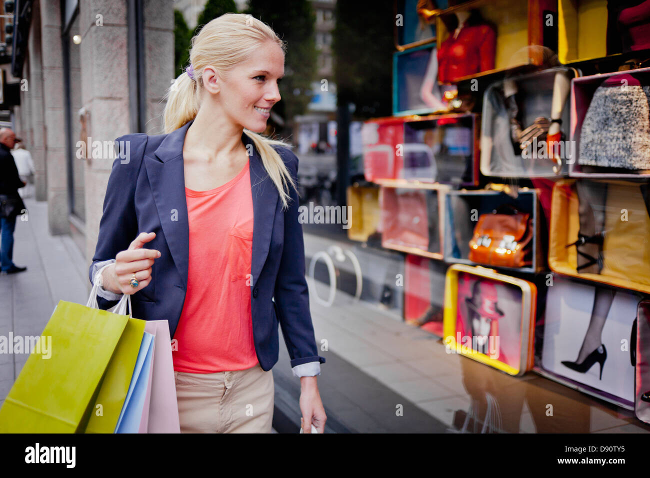 Woman with shopping bags window shopping Stock Photo - Alamy