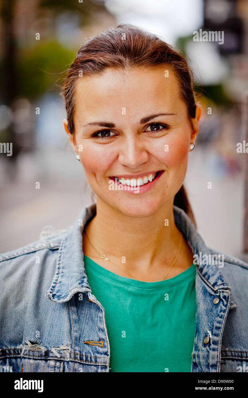 Portrait of woman smiling outdoors Stock Photo - Alamy