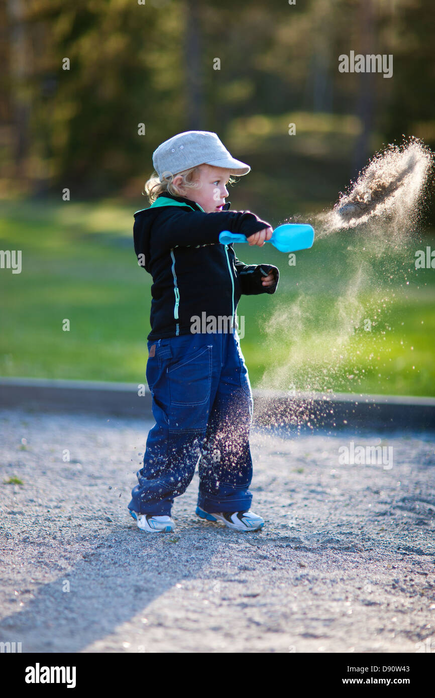 Boy throwing sand Stock Photo - Alamy