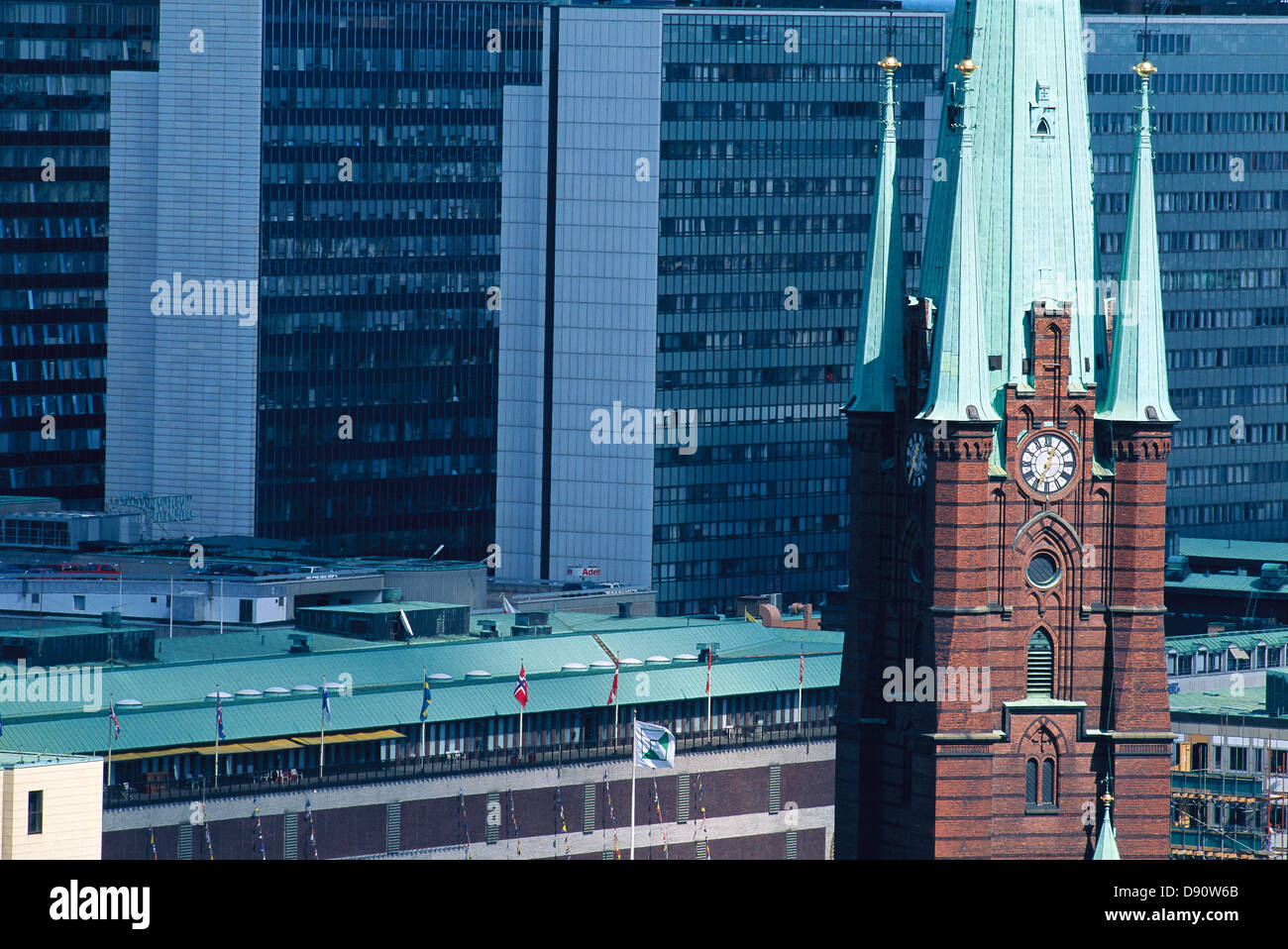 Clock tower by sky scrapers Stock Photo - Alamy