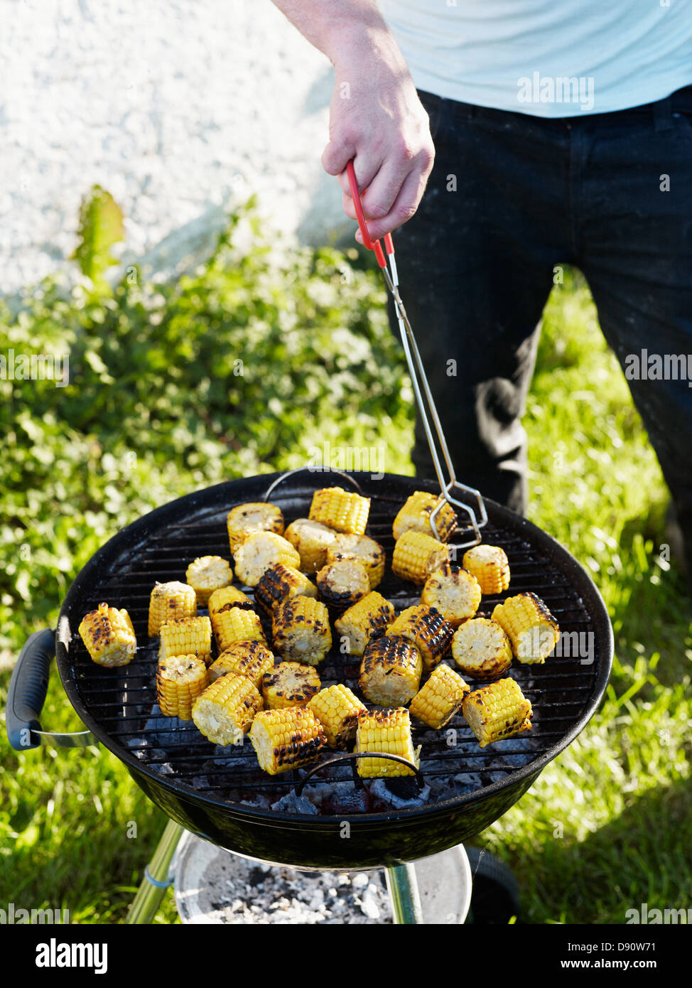 Grilling corn person hi-res stock photography and images - Alamy