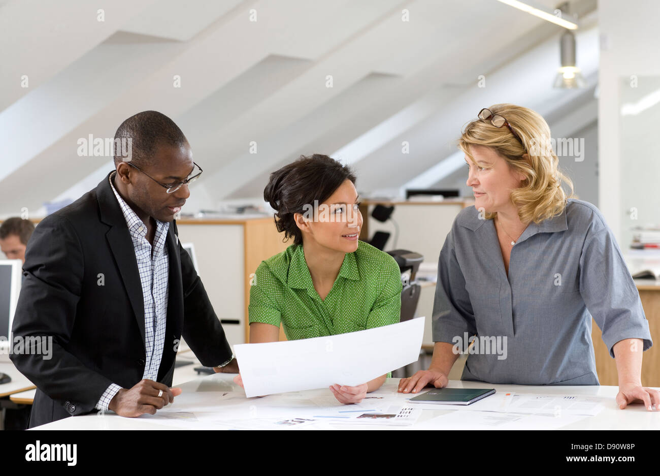Coworkers having discussion in office Stock Photo - Alamy