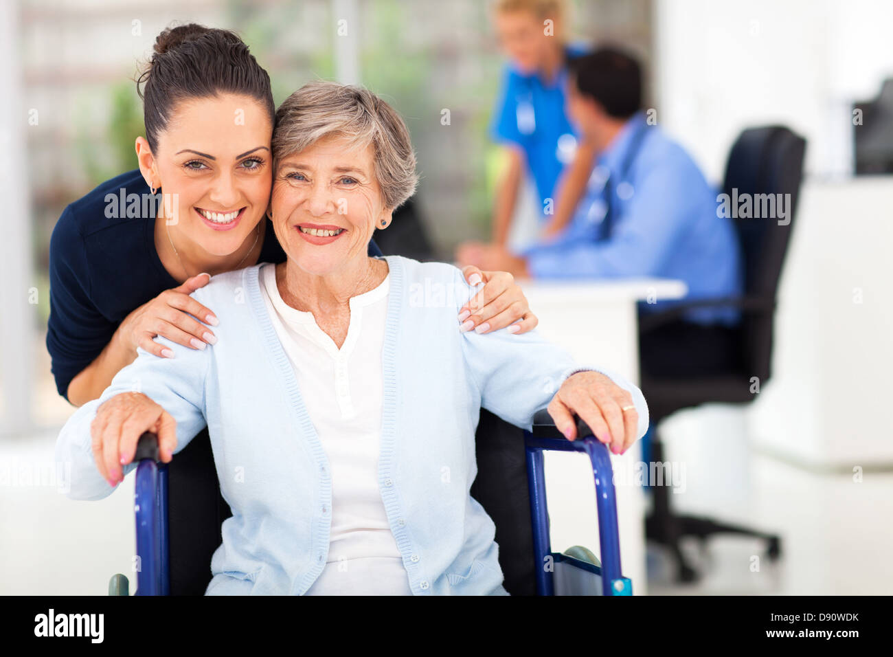 caring adult daughter accompanying senior mother visiting doctor Stock ...