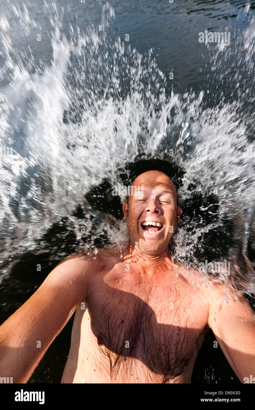 Man splashing into water Stock Photo - Alamy