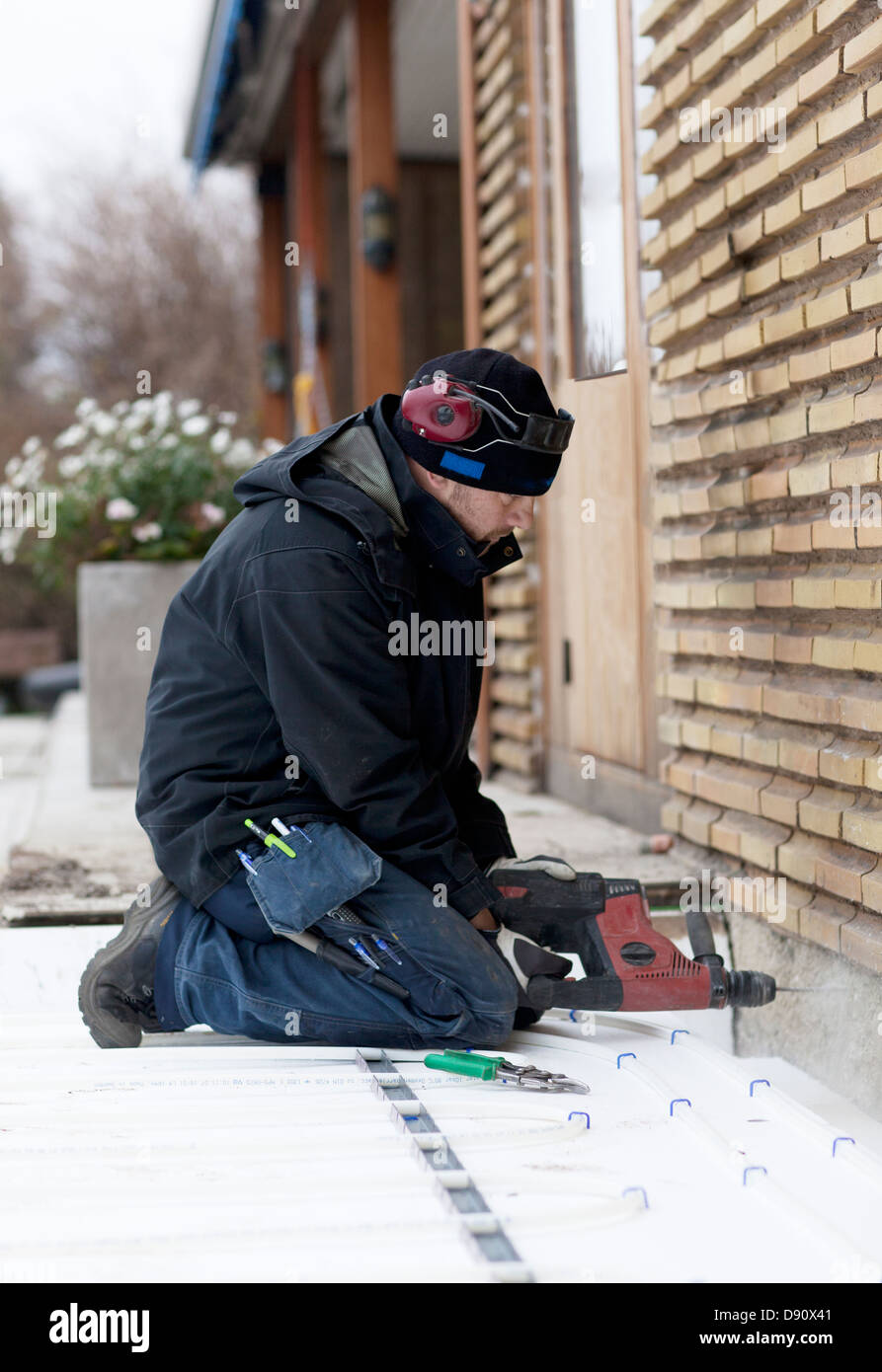 Man working outside house Stock Photo - Alamy