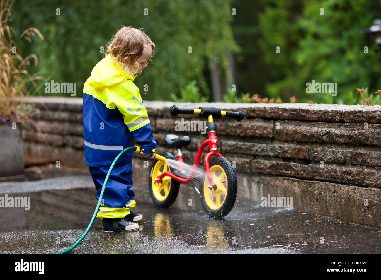 Boy washing bicycle Stock Photo - Alamy