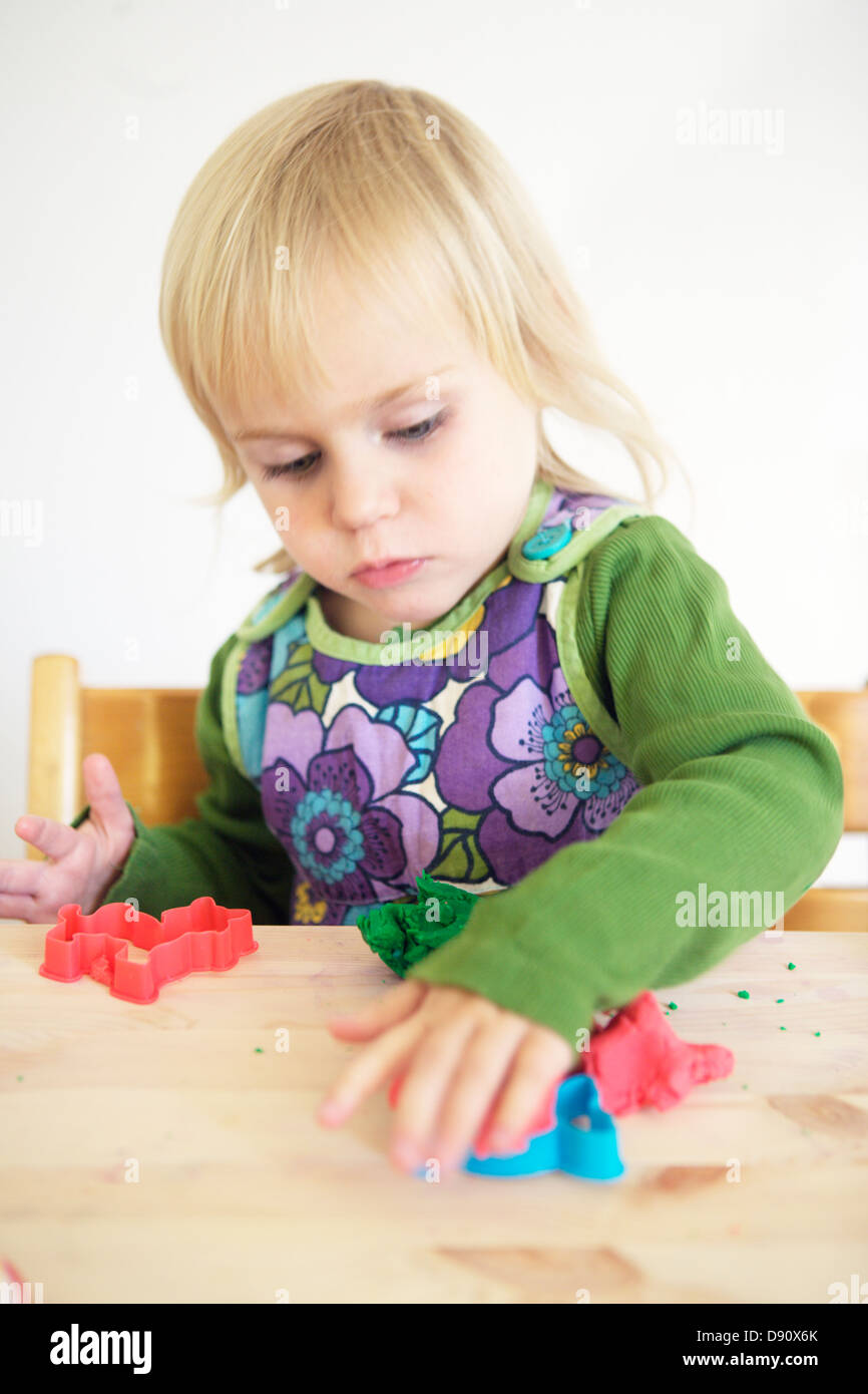 Girl playing with colorful mud Stock Photo - Alamy