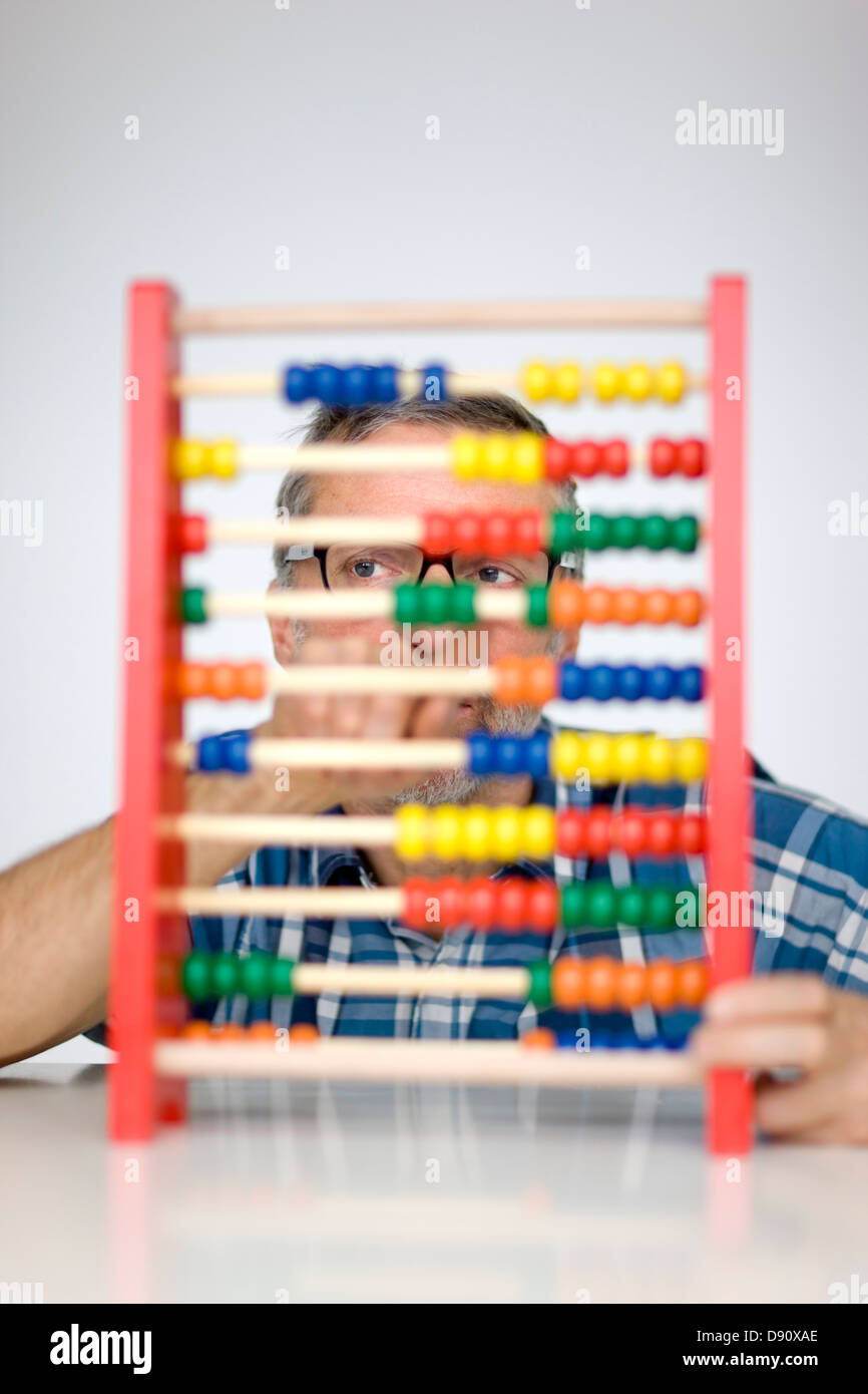 Man behind colorful abacus Stock Photo - Alamy