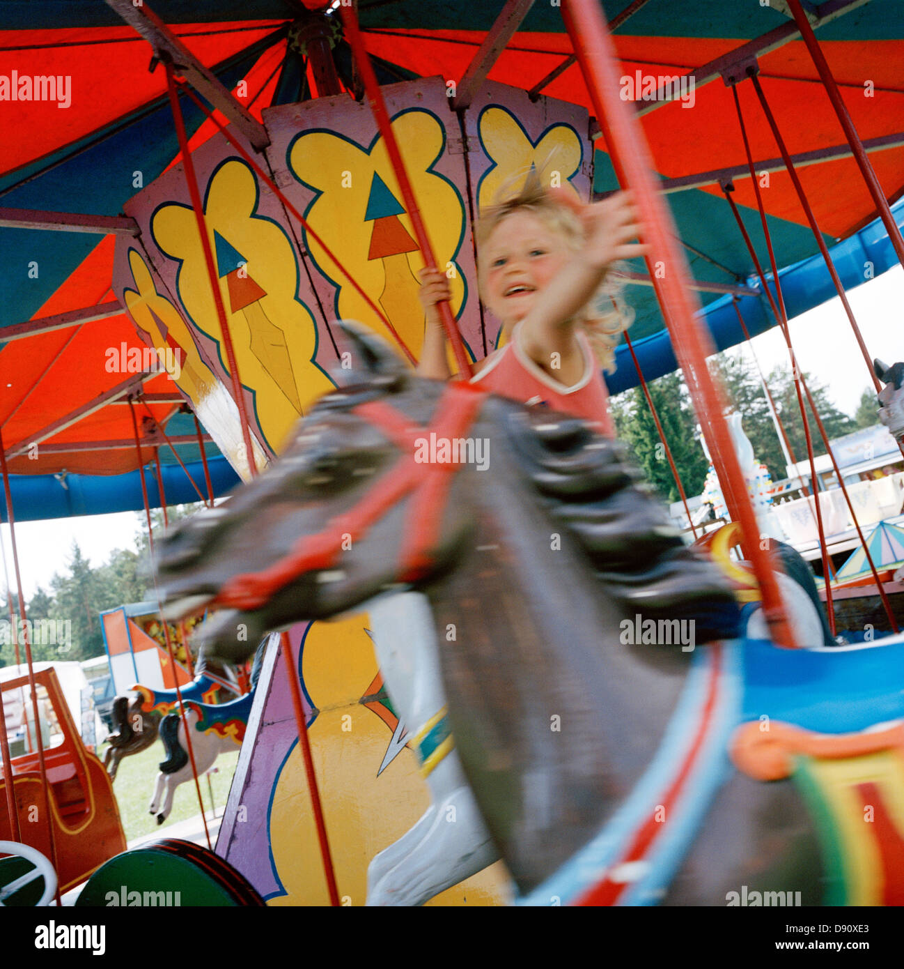 Girl riding on merry go round hi-res stock photography and images - Alamy