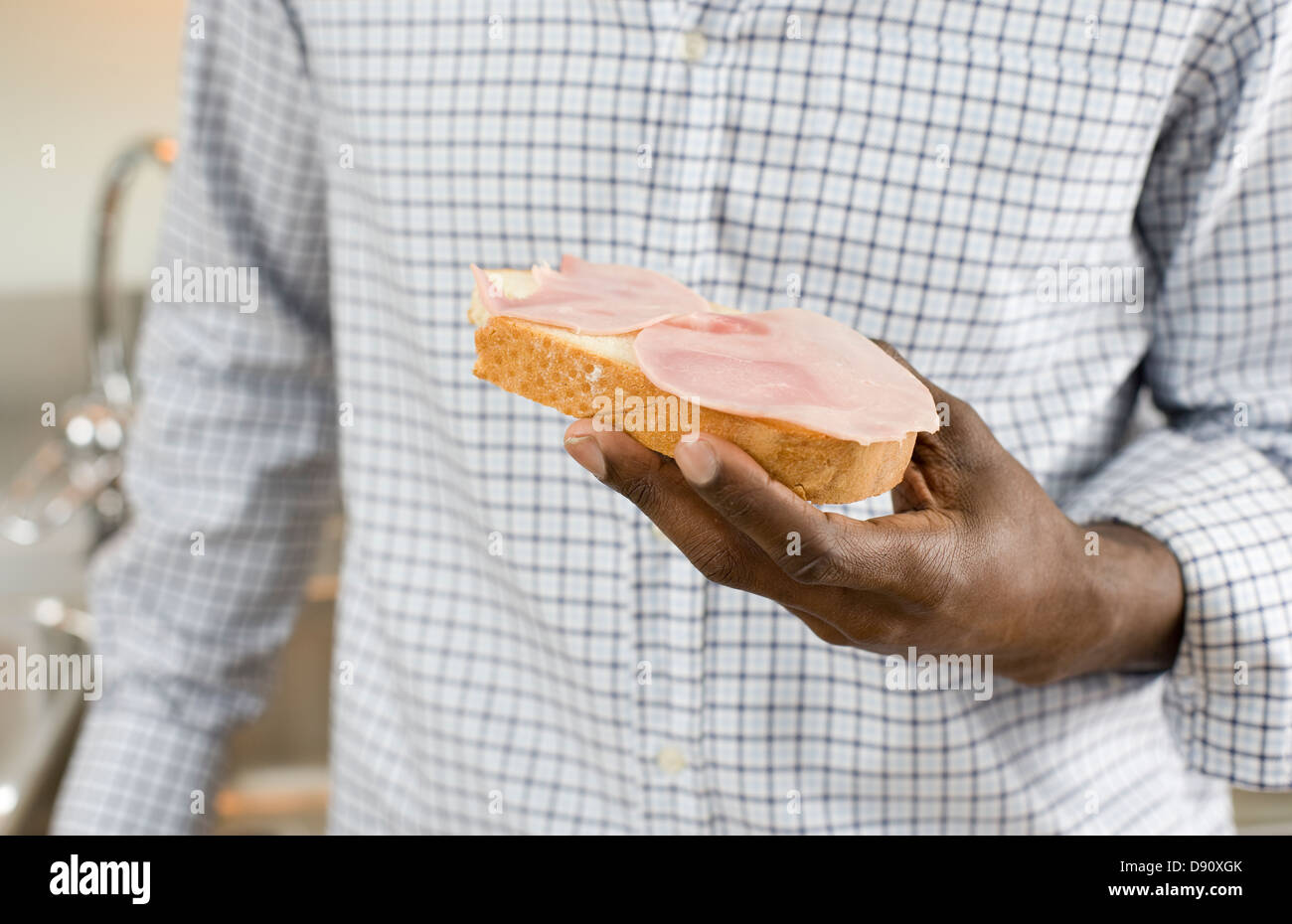 Close up of man''s hand holding sandwich Stock Photo - Alamy