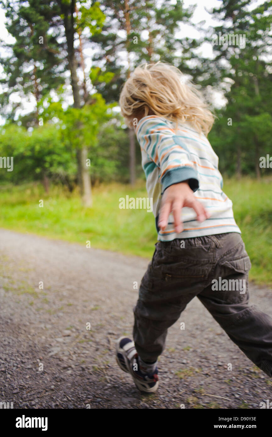 Child running through forest Stock Photo - Alamy