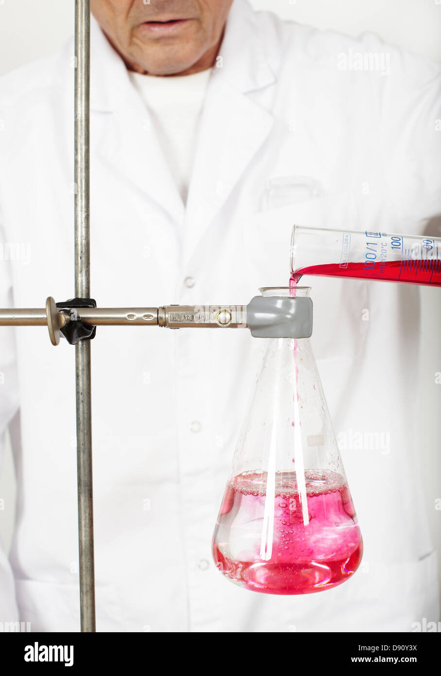 Scientist pouring chemical into beaker, mid section Stock Photo - Alamy