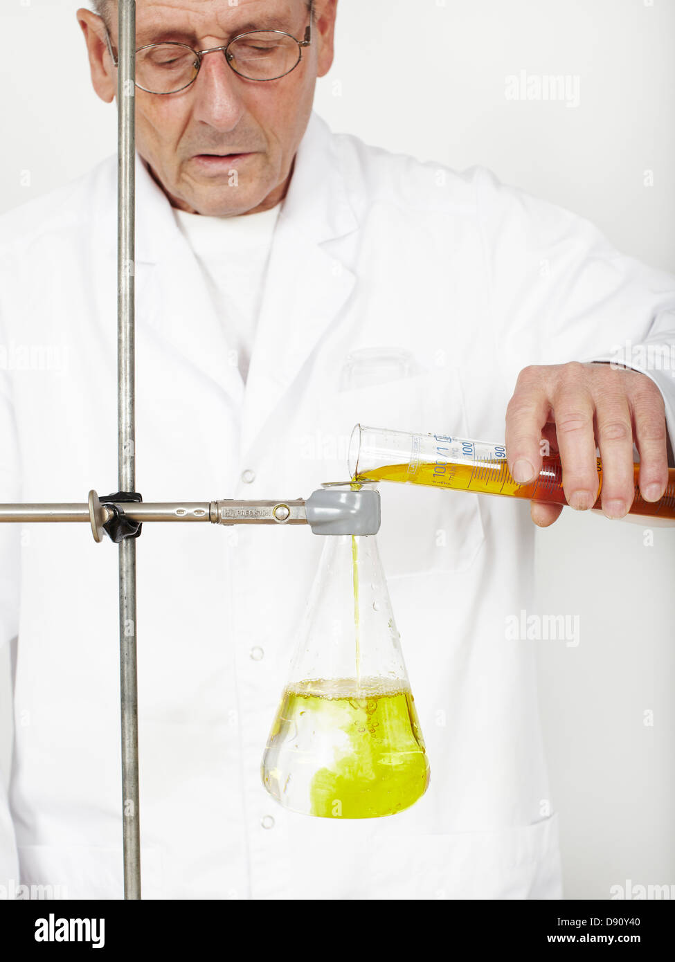 Person pouring test tube into beaker hi-res stock photography and ...