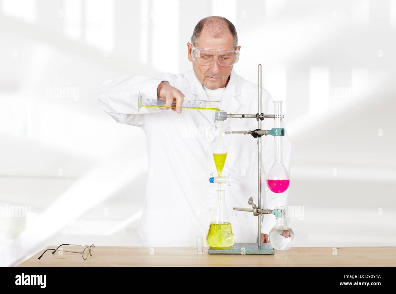 Scientist pouring chemical into beaker in laboratory Stock Photo - Alamy