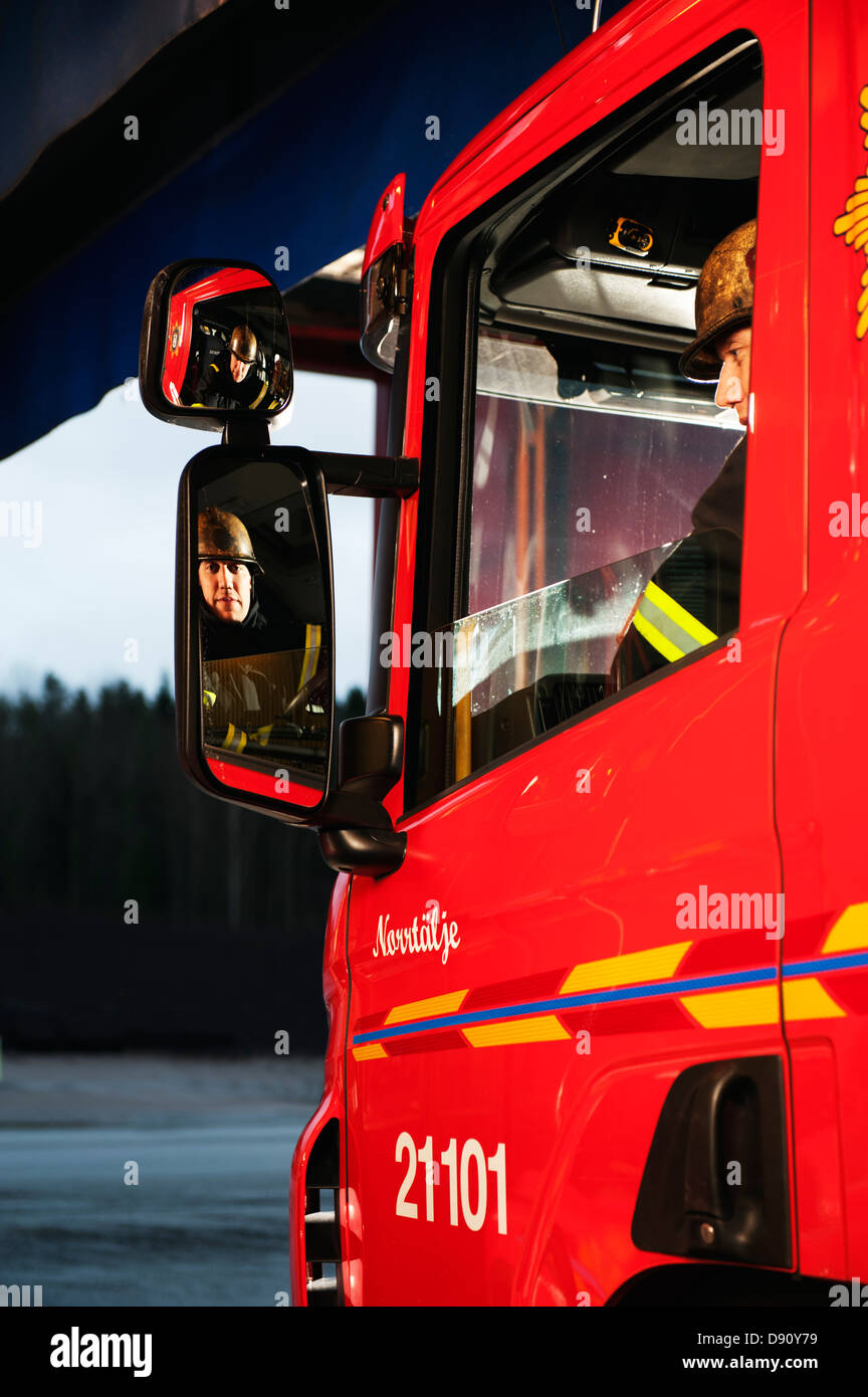 Firefighter driving fire engine Stock Photo - Alamy