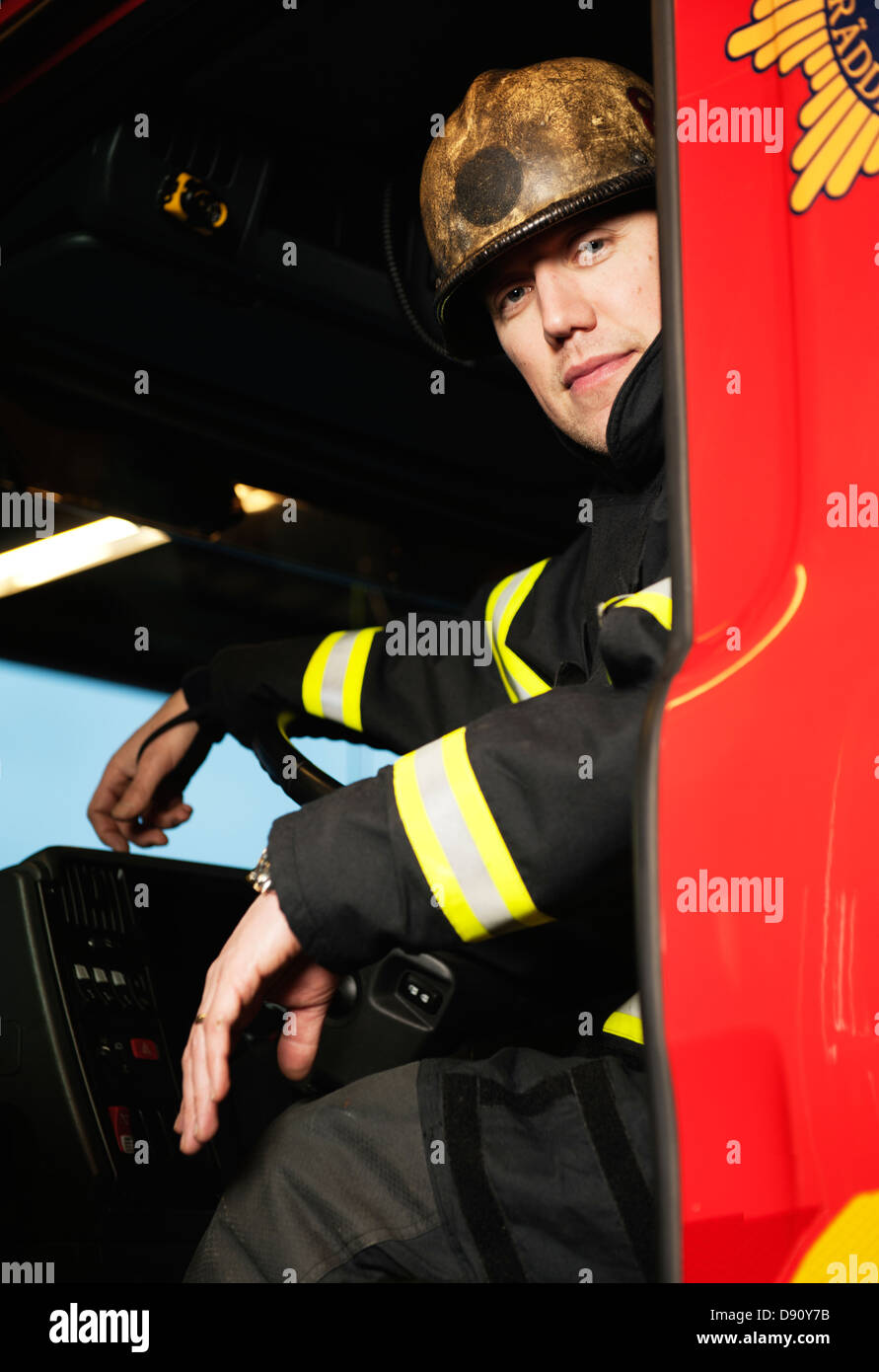 Firefighter driving fire engine Stock Photo - Alamy