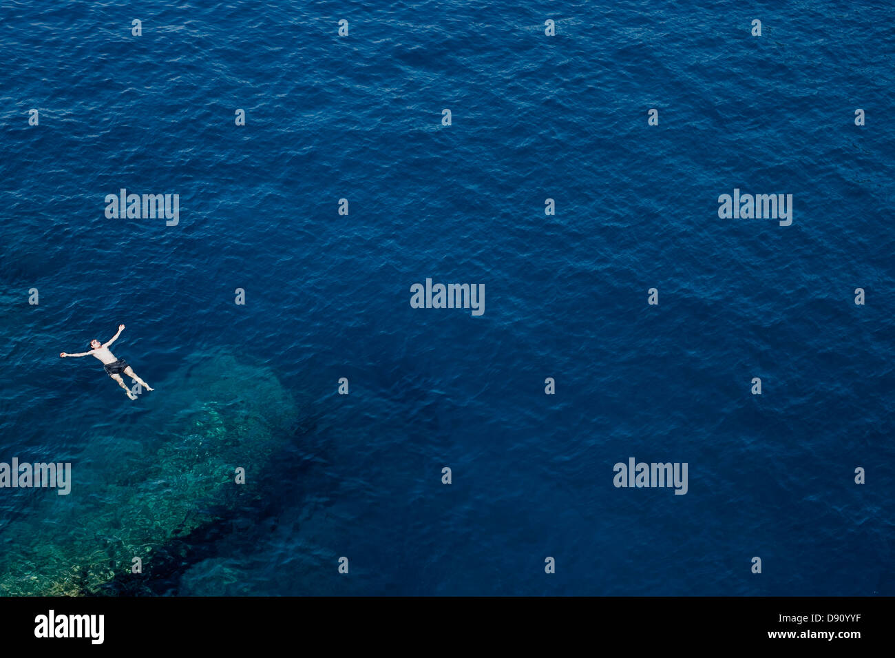 A man floating in the ocean, Italy Stock Photo - Alamy