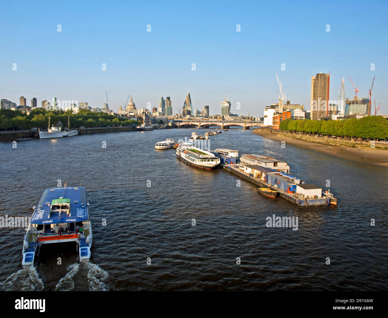 Thames Clippers on the River Thames showing the City of London's ...