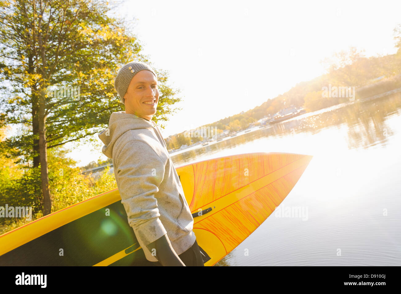 Man carrying paddle board hi-res stock photography and images - Alamy