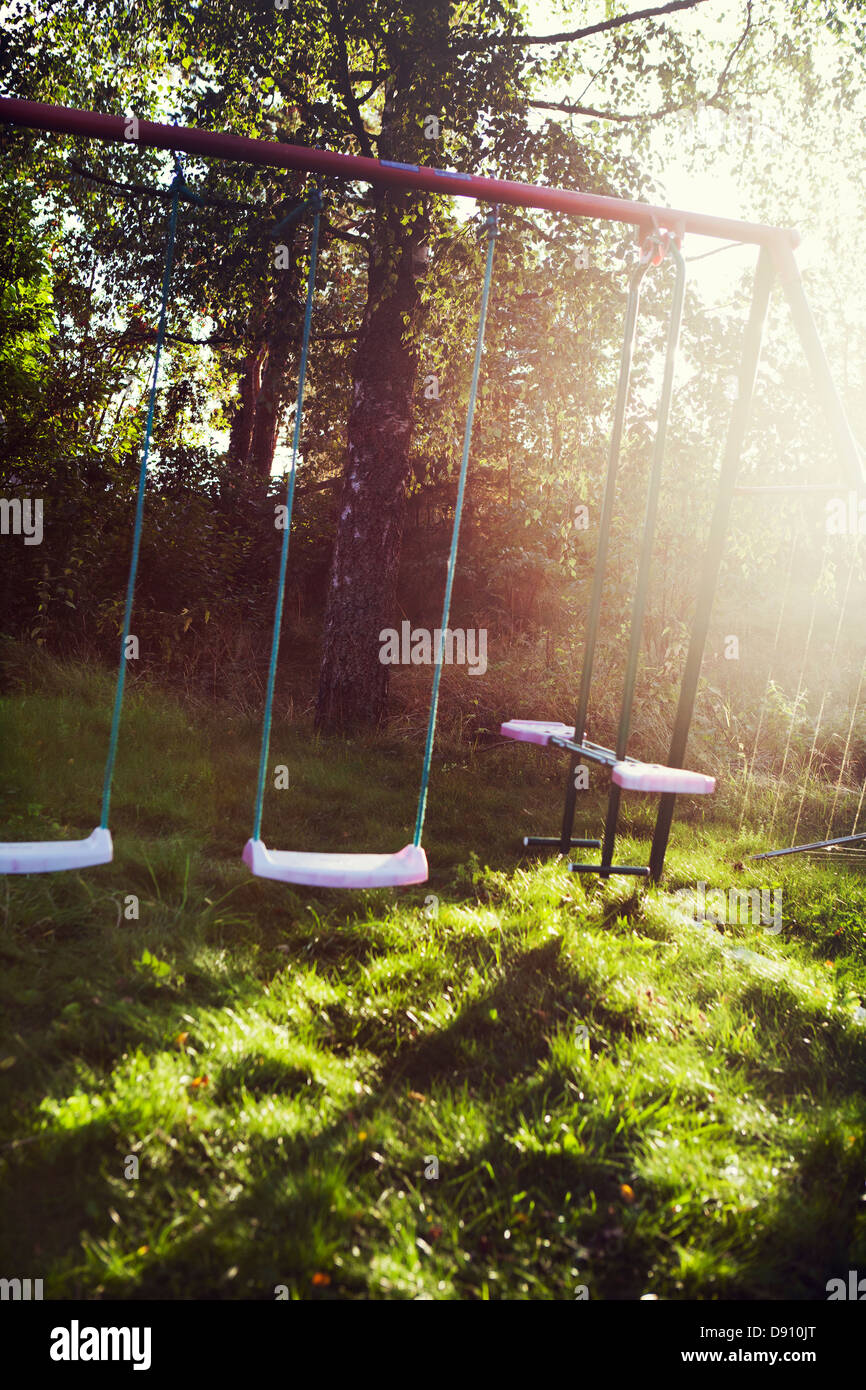 Empty swing in playground Stock Photo - Alamy