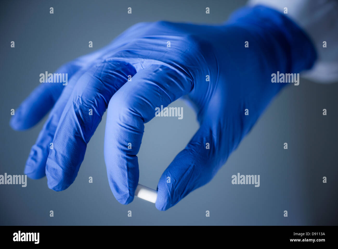 Person in blue glove hi-res stock photography and images - Alamy