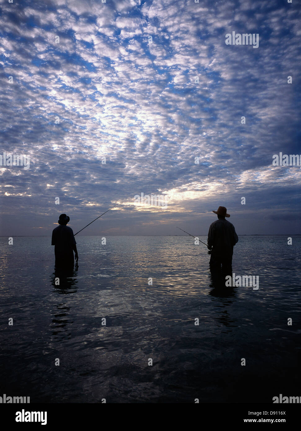 Two fishermen standing in the ocean, Mauritius Stock Photo - Alamy