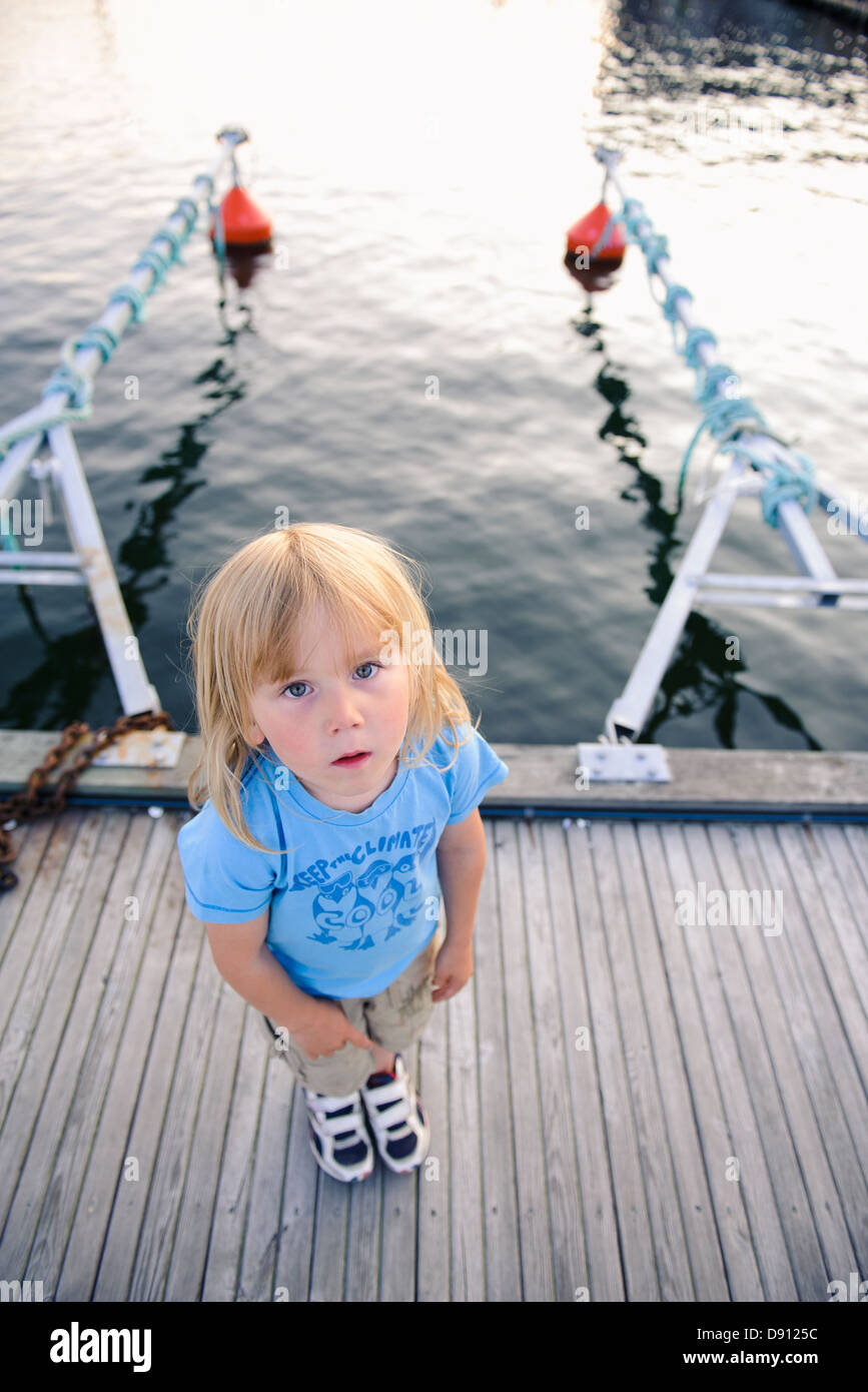 Portrait of boy on jetty Stock Photo - Alamy