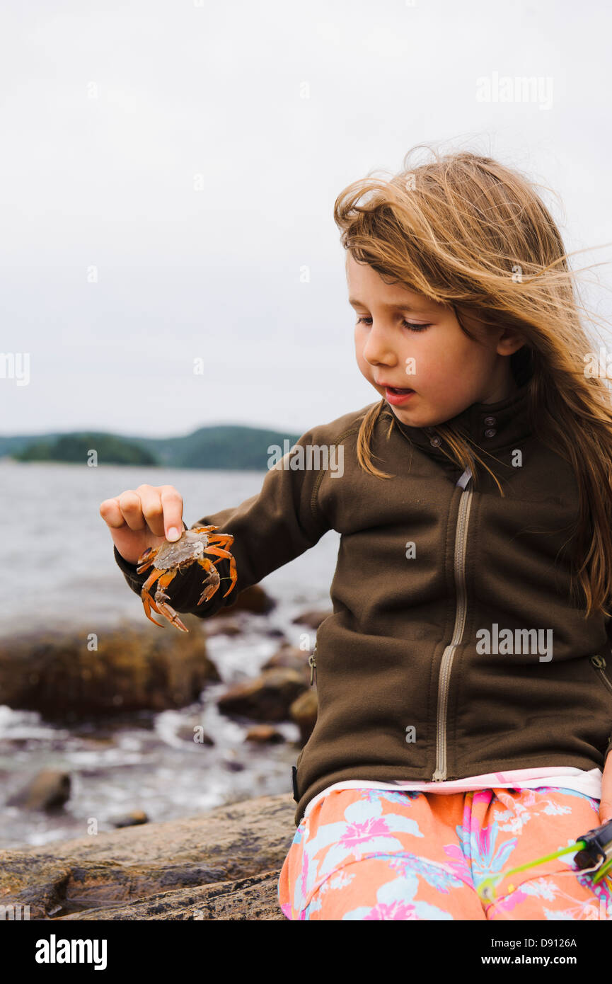 Girl holding crab Stock Photo - Alamy