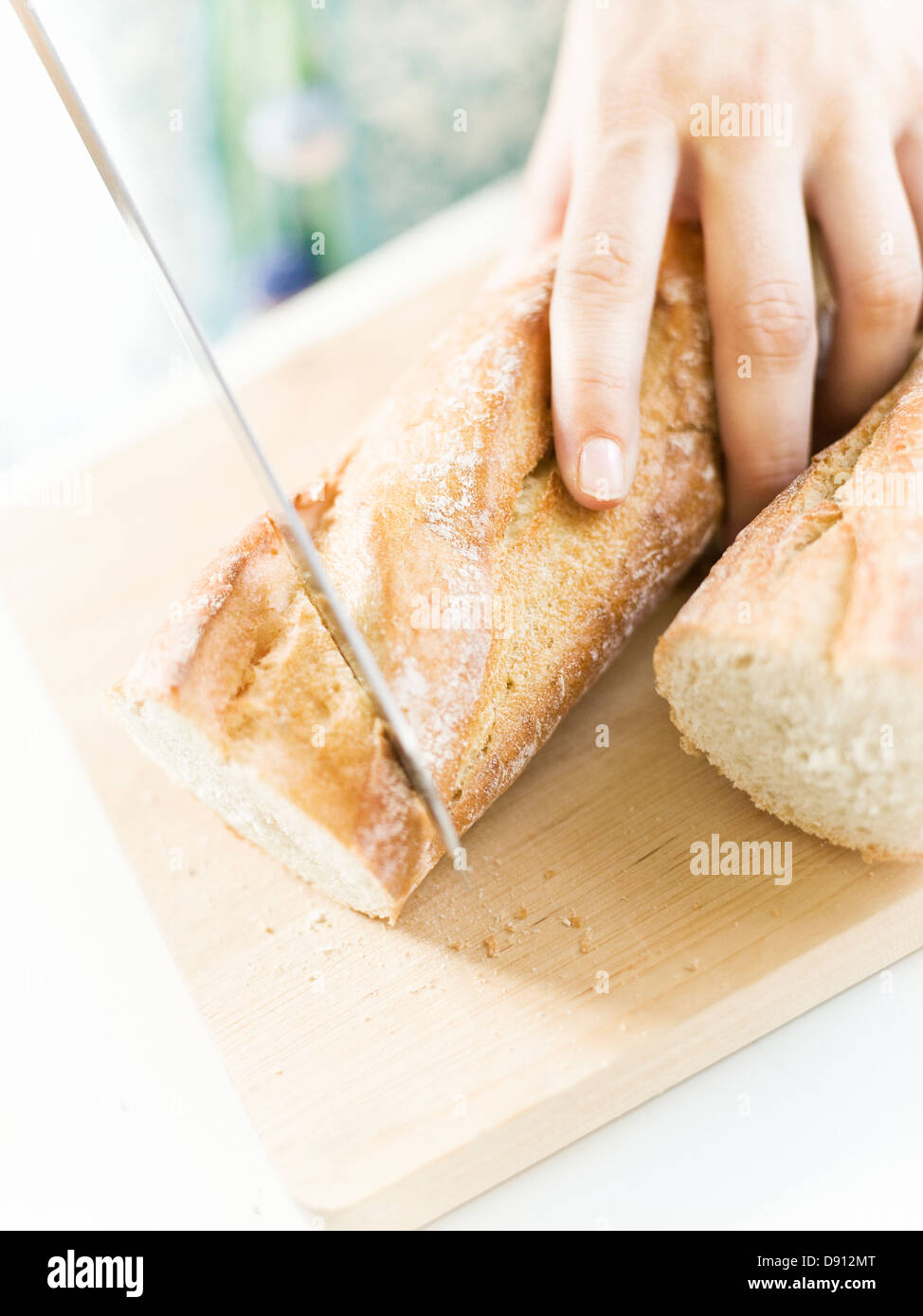 Bread being sliced, Sweden Stock Photo - Alamy