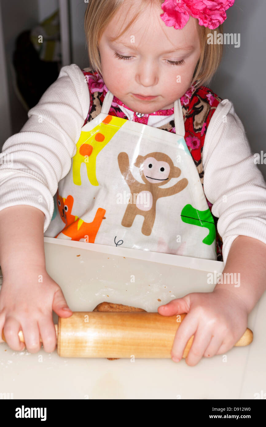 Girl rolling gingerbread Stock Photo - Alamy