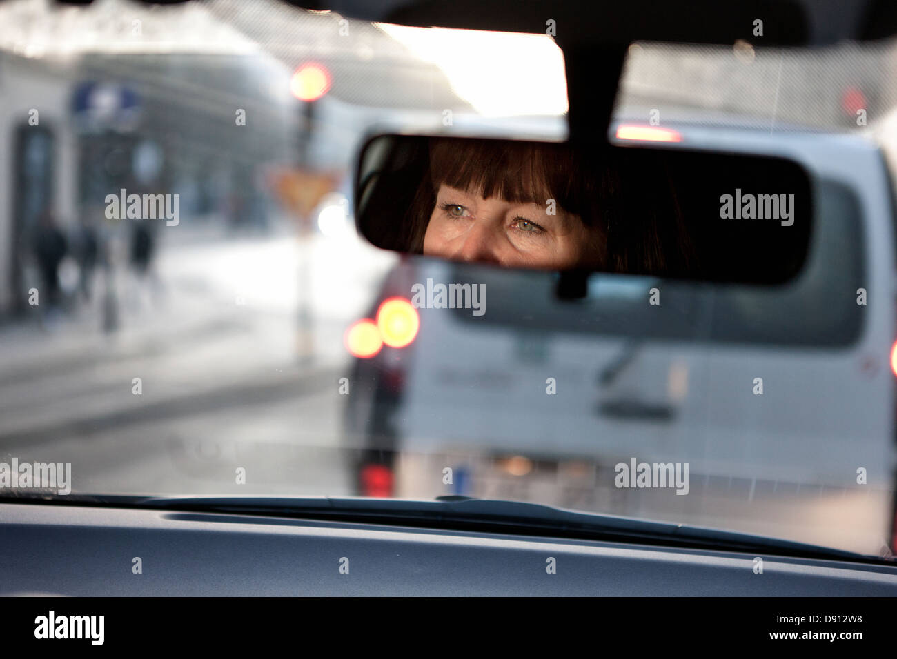 Woman reflecting in rear view mirror Stock Photo - Alamy