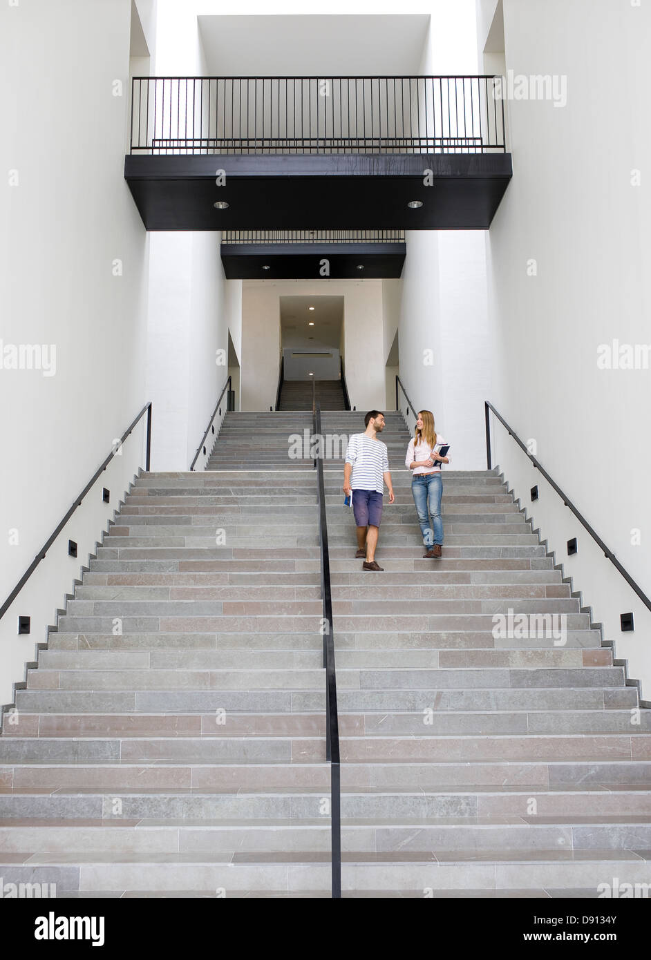 Young students walking on stairs Stock Photo - Alamy