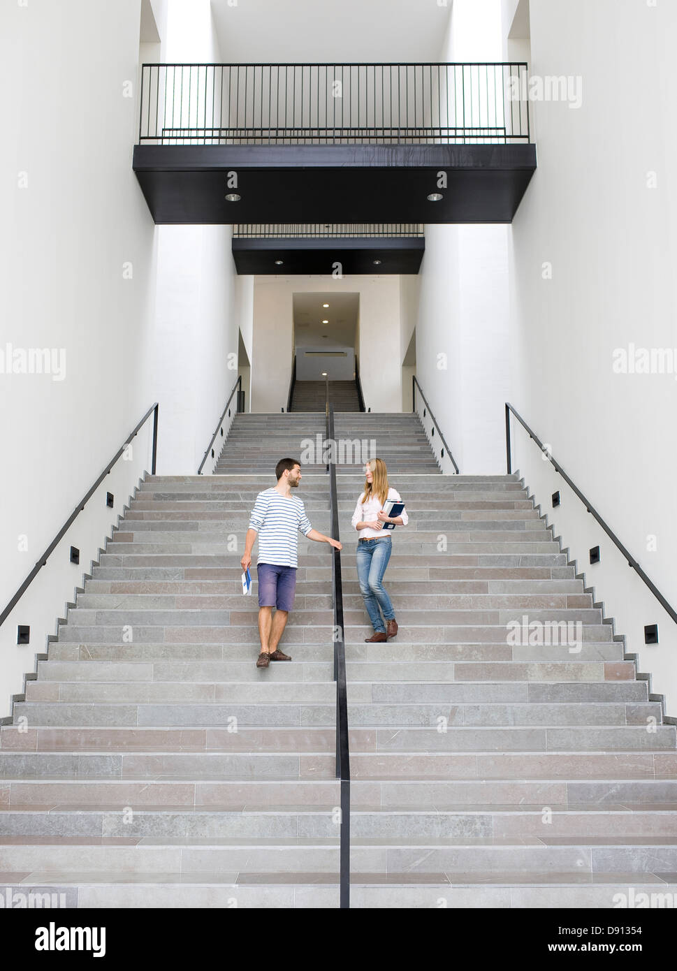 Young students walking on stairs Stock Photo - Alamy