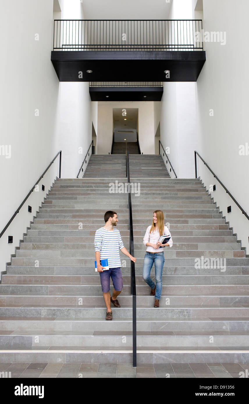 Young students walking on stairs Stock Photo - Alamy