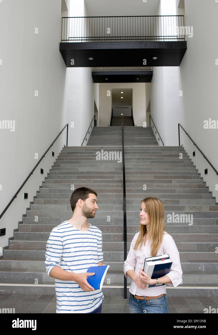 Young students with stairs in background Stock Photo - Alamy