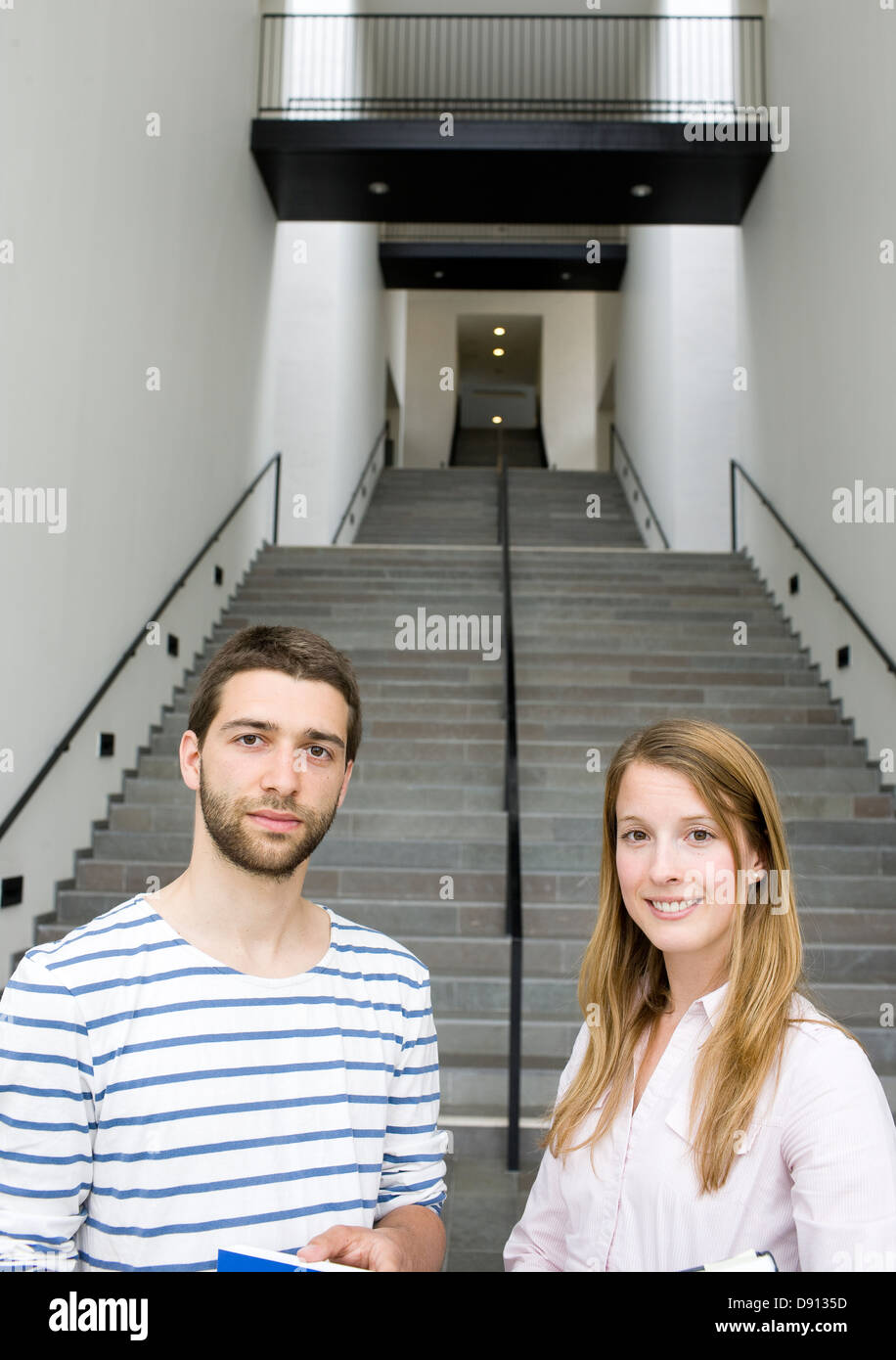 Young students with stairs in background Stock Photo - Alamy
