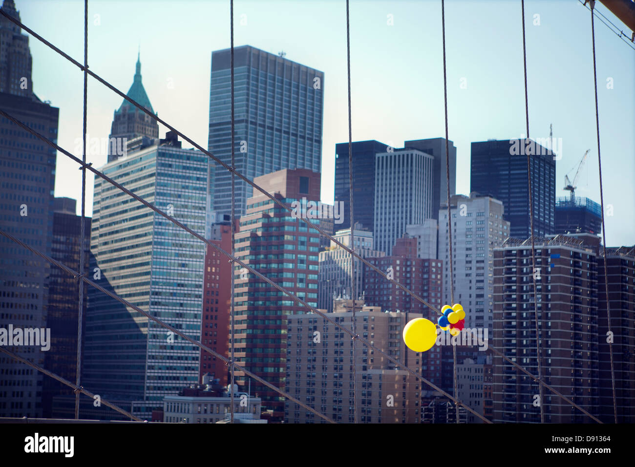 Colorful balloons on Brooklyn Bridge with skyscrapers in background ...