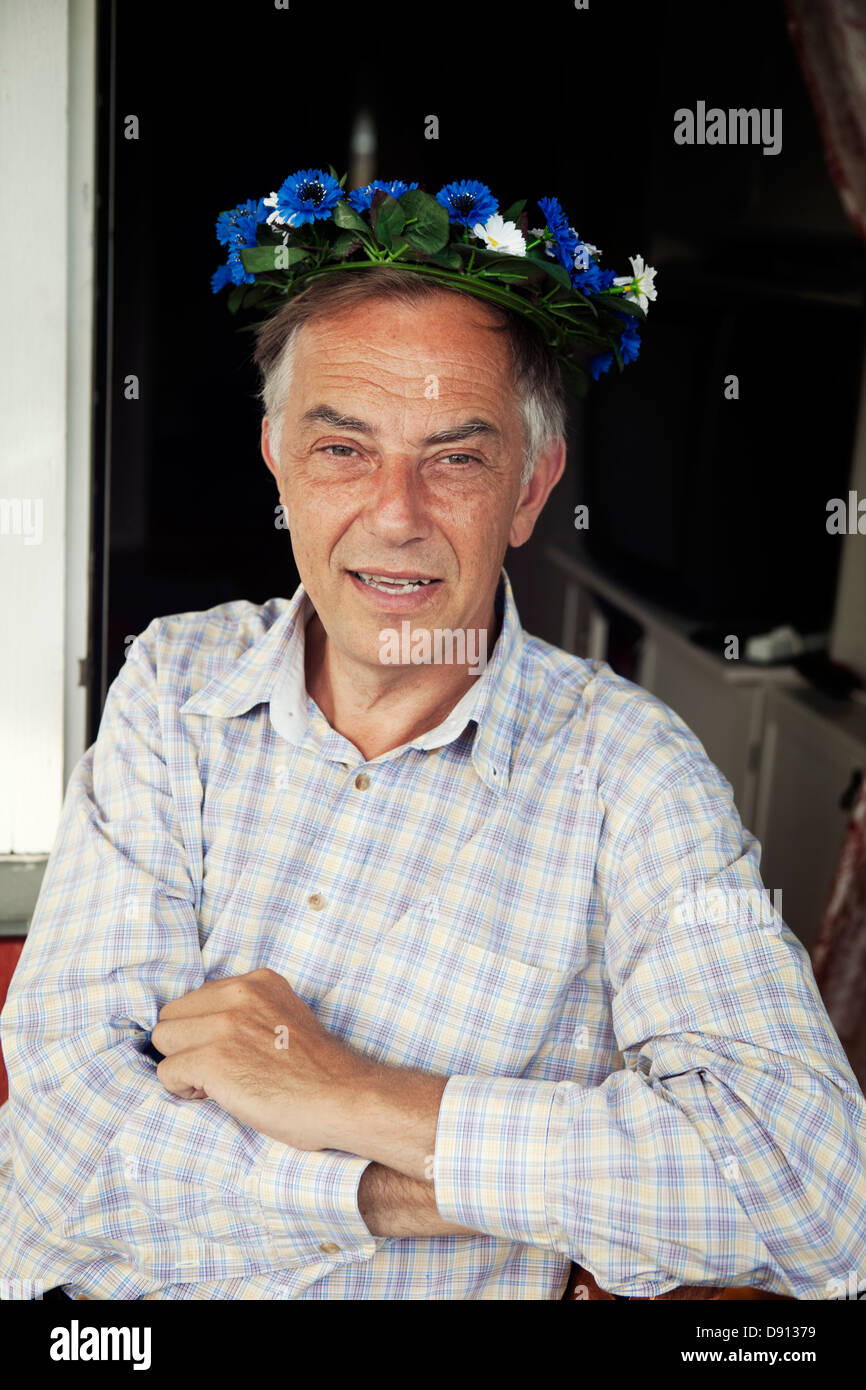 Senior man wearing midsummer wreath Stock Photo - Alamy