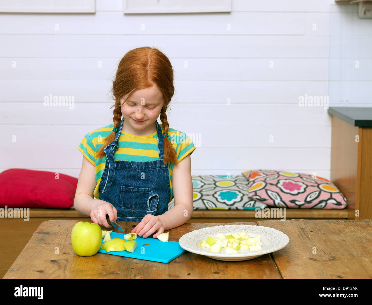 Girl peeling apple in kitchen Stock Photo - Alamy