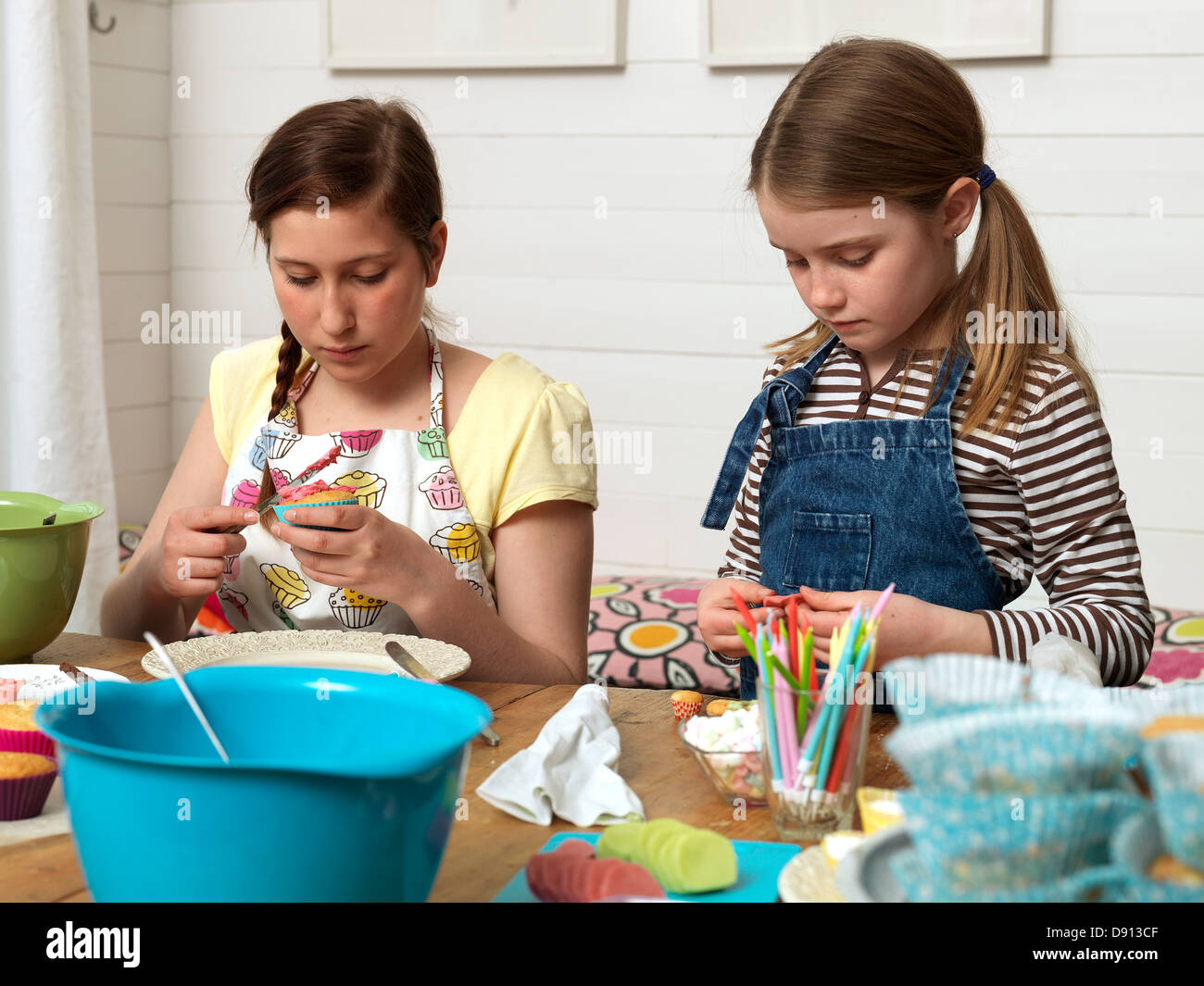 Two girls baking cake in kitchen Stock Photo - Alamy