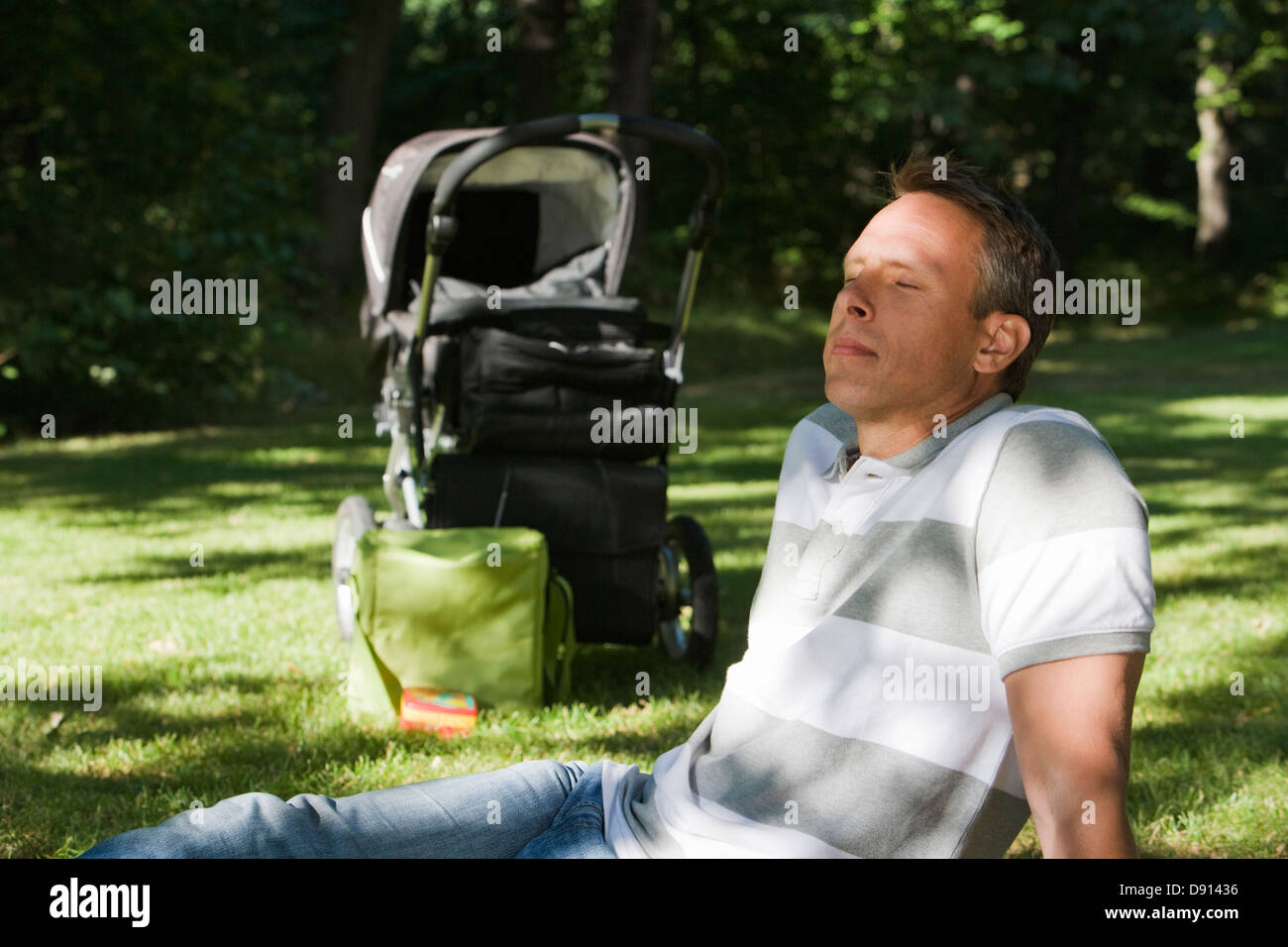 A man with a pram and a computer in a park a sunny day, Sweden Stock ...