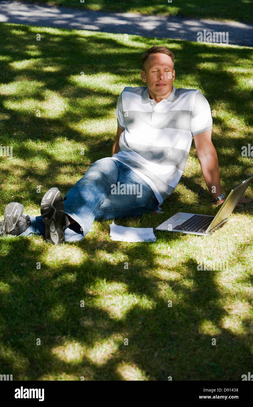 A man with a pram and a computer in a park a sunny day, Sweden Stock ...