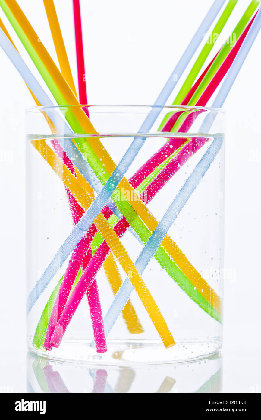 Colorful drinking straws in glass of water Stock Photo - Alamy