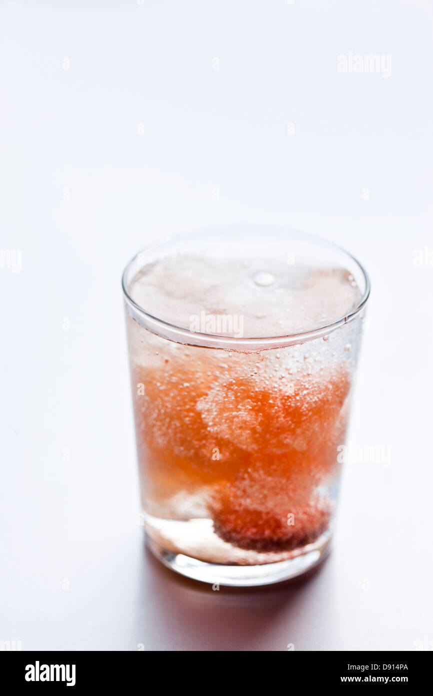 Pill melting in glass of water Stock Photo - Alamy