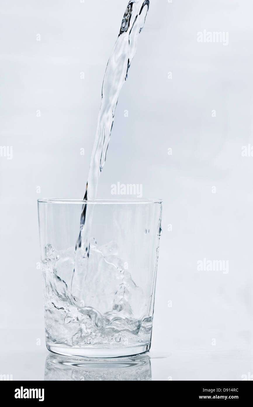 Pouring water into glass Stock Photo - Alamy