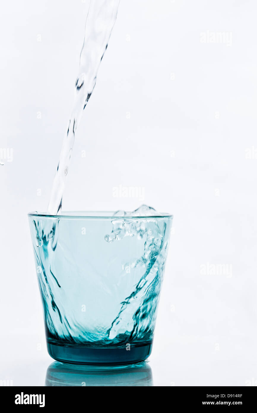 Pouring water into glass Stock Photo - Alamy