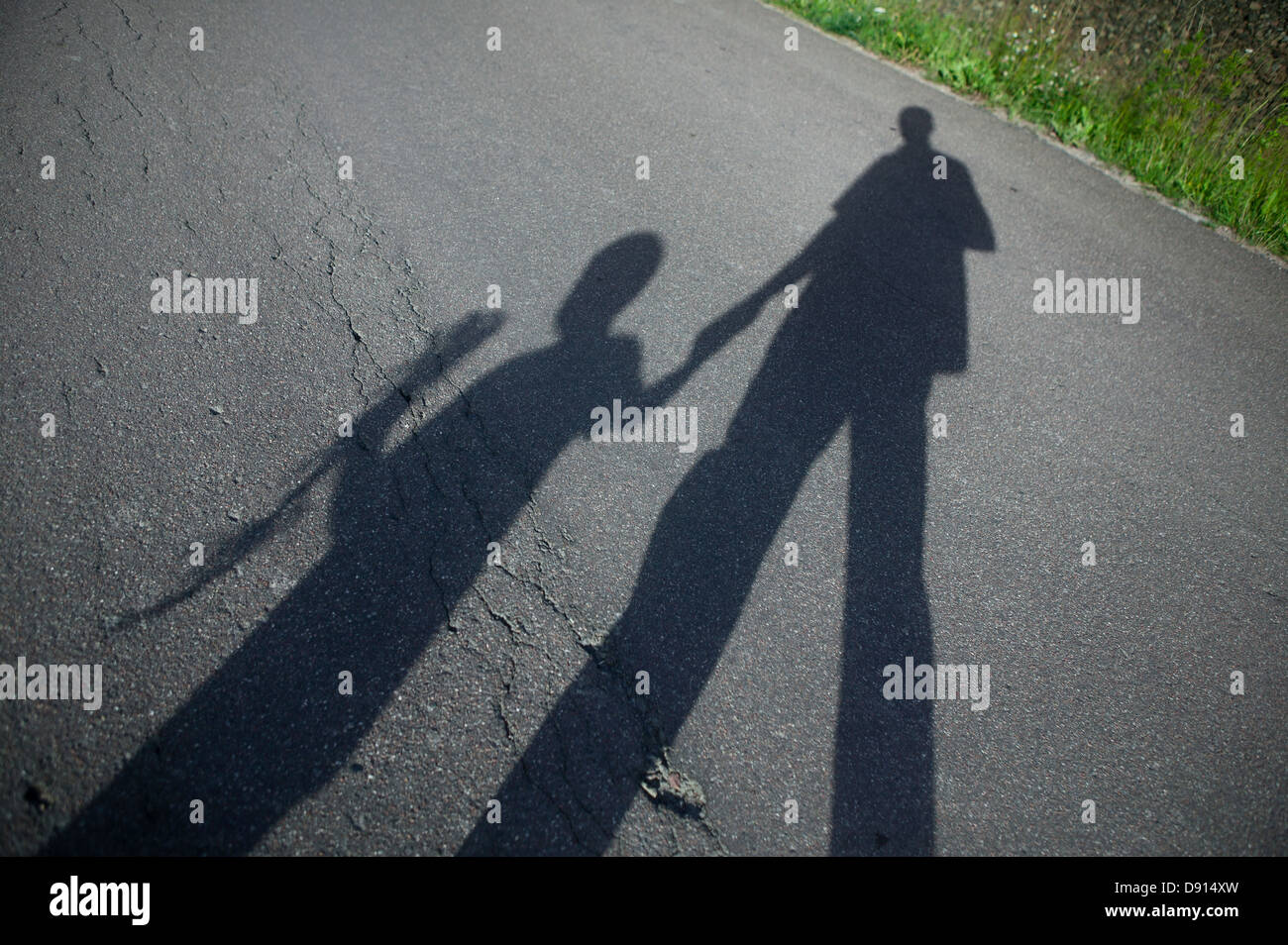 Shadow of father and boy on road Stock Photo - Alamy