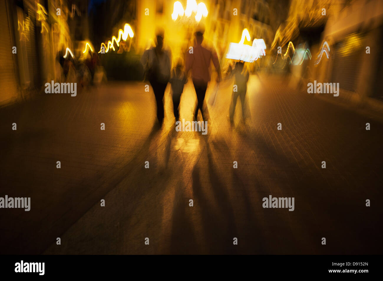 Family walking on street at night Stock Photo - Alamy