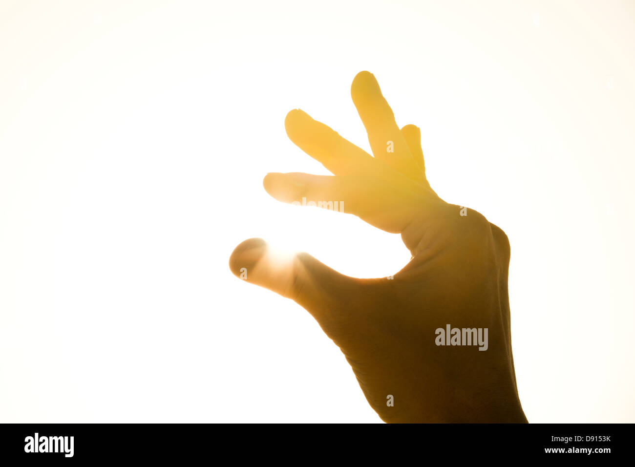 Human hand holding sun Stock Photo - Alamy